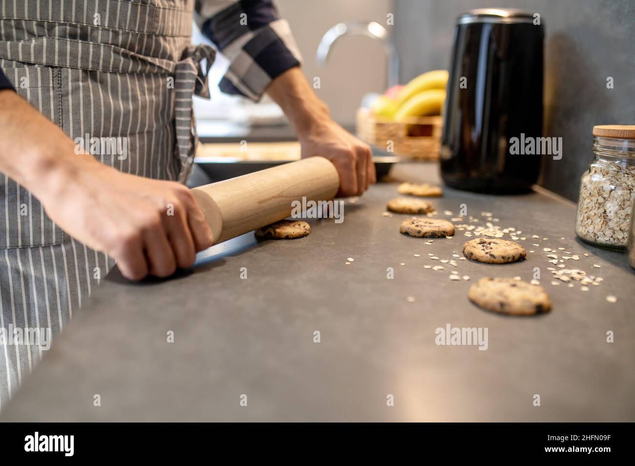 Male hands leveling surface of raw cookie with rolling pin Stock Photo ...
