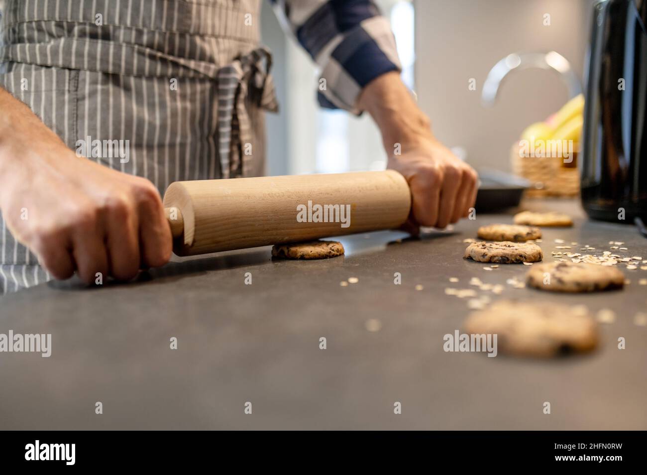 Hands of man pressing rolling pin on raw cookie Stock Photo - Alamy