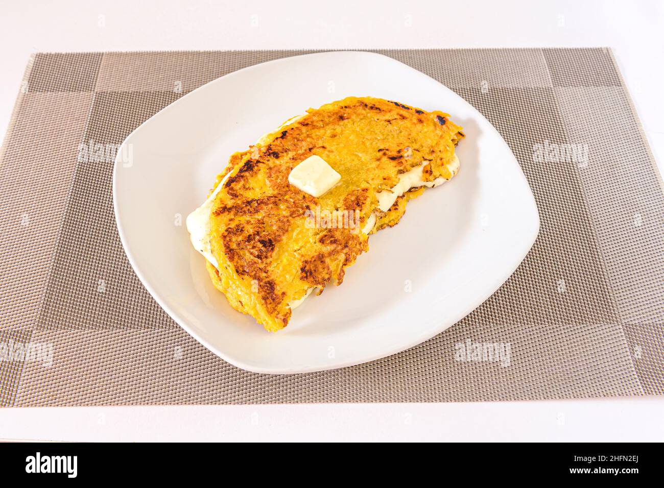 Cachapa is a typical corn-based dish stuffed with fresh cheese on a ...