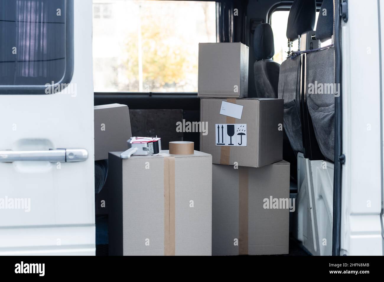 Adhesive tape on carton boxes with signs in car Stock Photo - Alamy