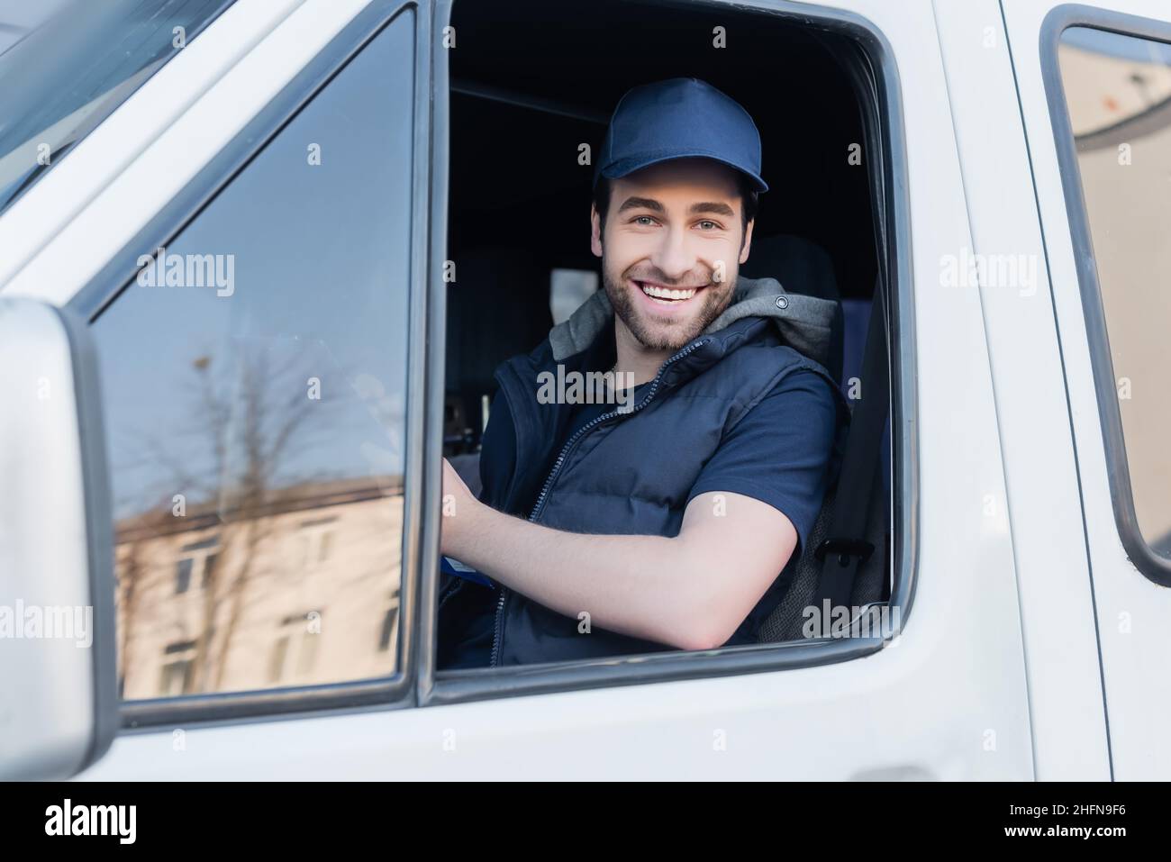 Happy positive courier in hi-res stock photography and images - Alamy
