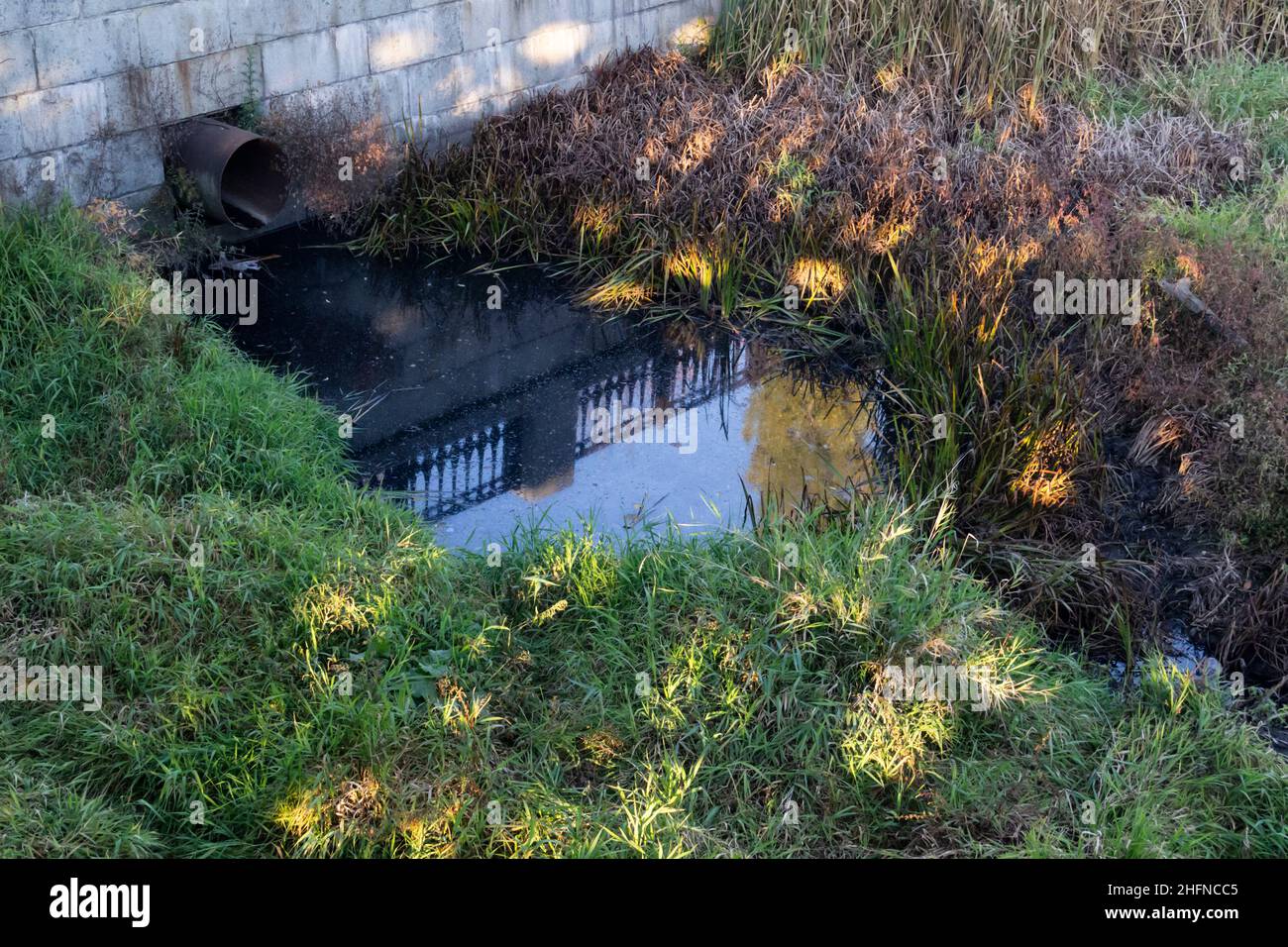 Pollution in the river In Ukraine in the city Sumy. A rusted metal ...