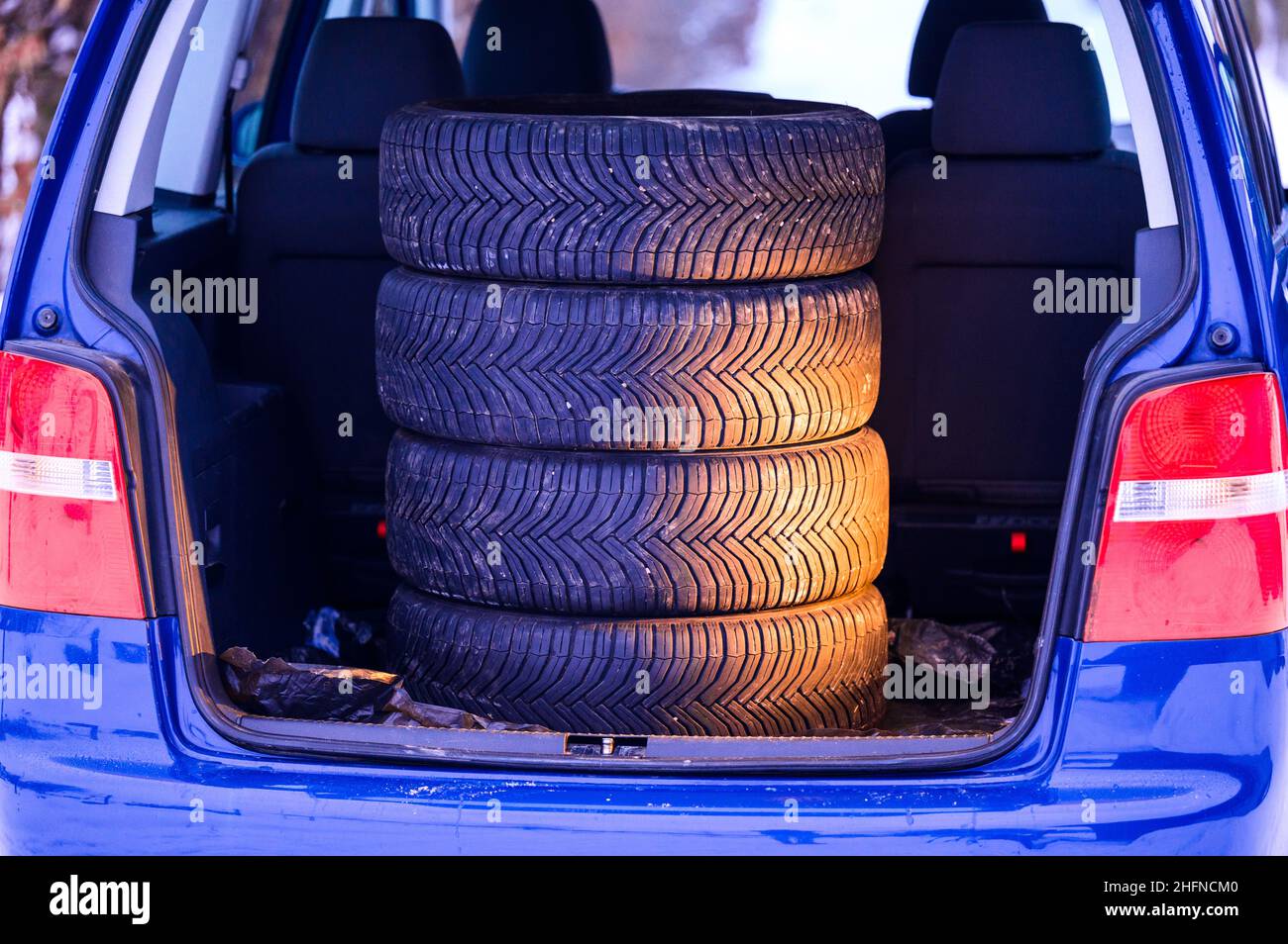 Set of all-season tires in the trunk of the car, four interchangeable ...