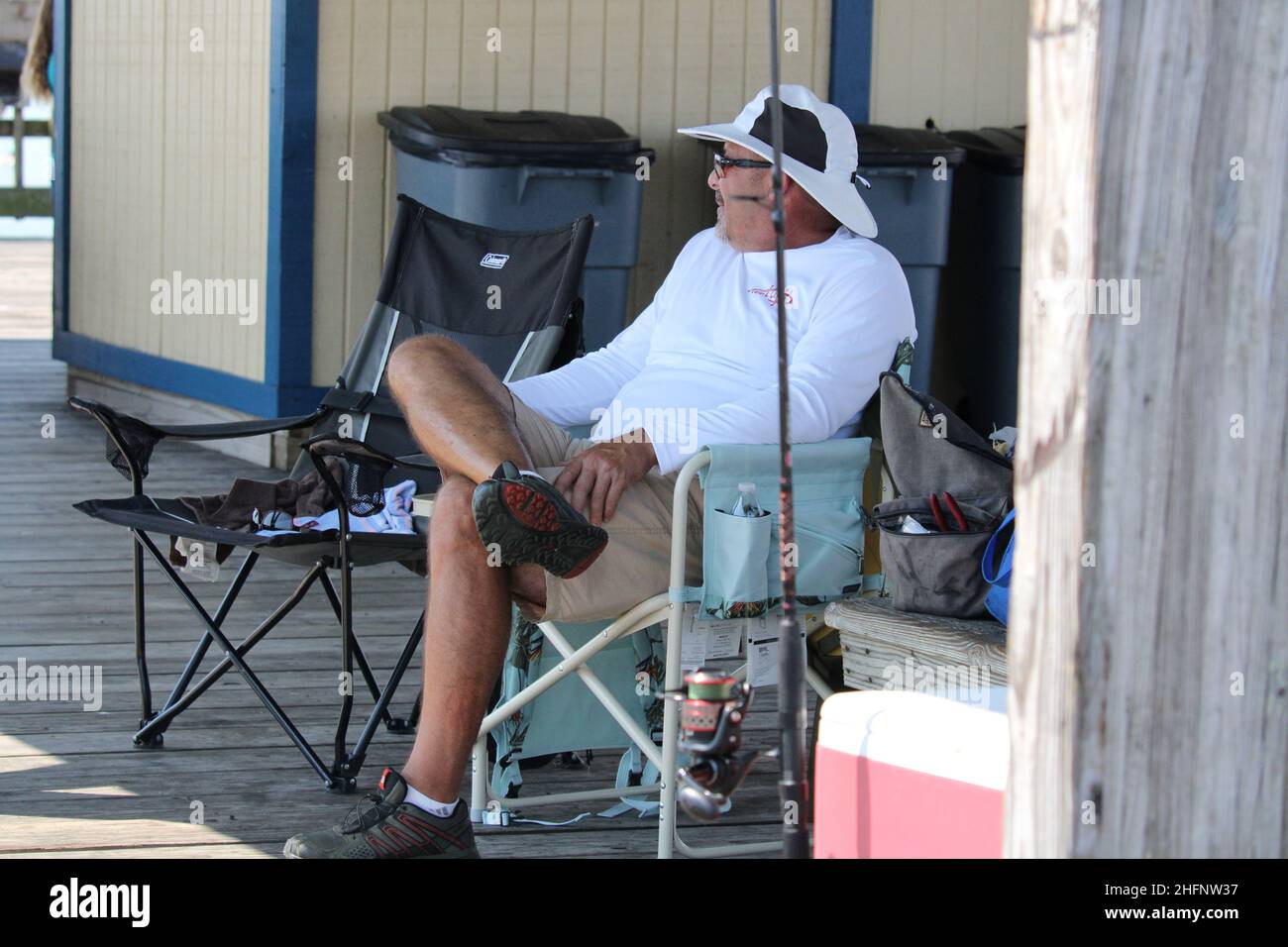 Pier fishing watching and waiting Stock Photo - Alamy