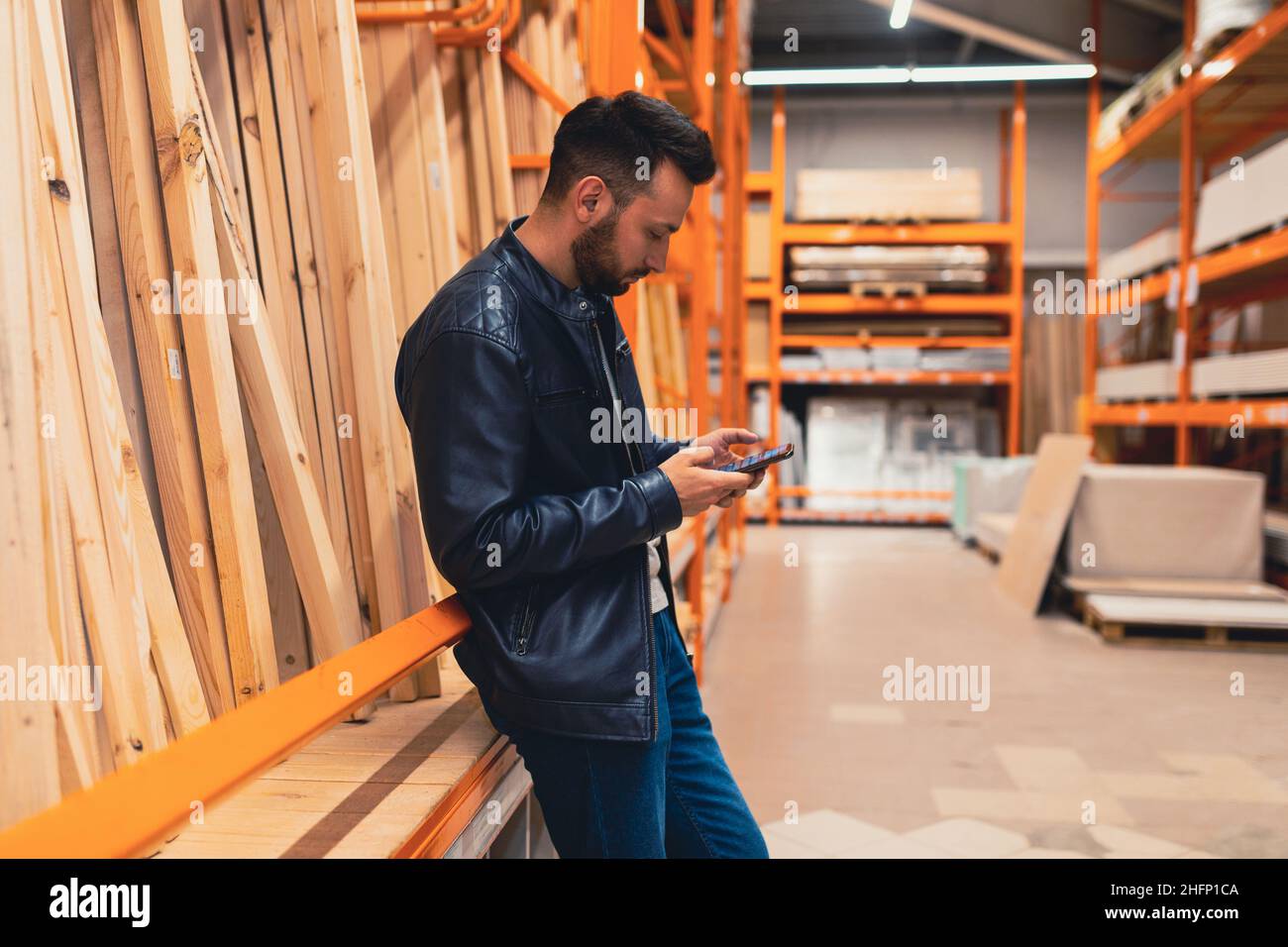 a buyer in a hardware store in the lumber department chooses boards and ...