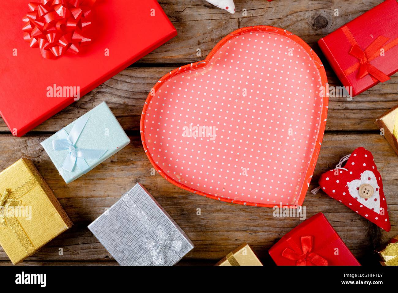 Overhead view of empty red heart shape gift box with copy space amidst ...