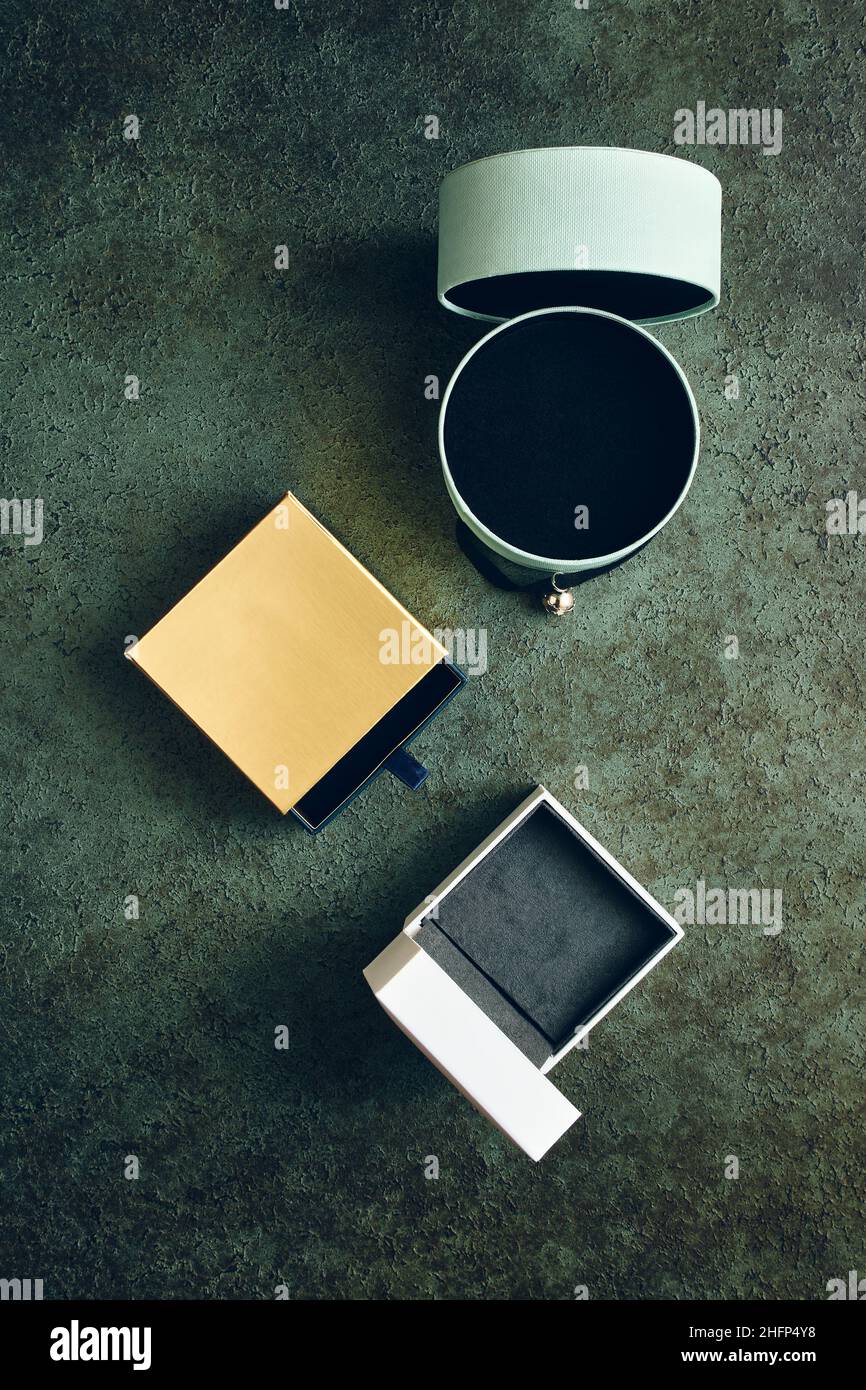 Three different gift boxes on green textured background toned in retro ...