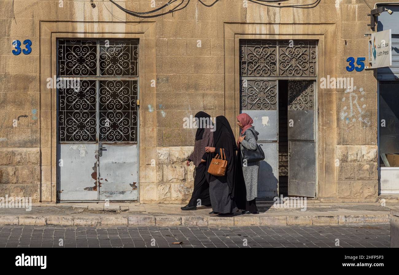 AMMA, JORDAN - DECEMBER 28, 2021: Muslim women, dressed in an Islamic ...