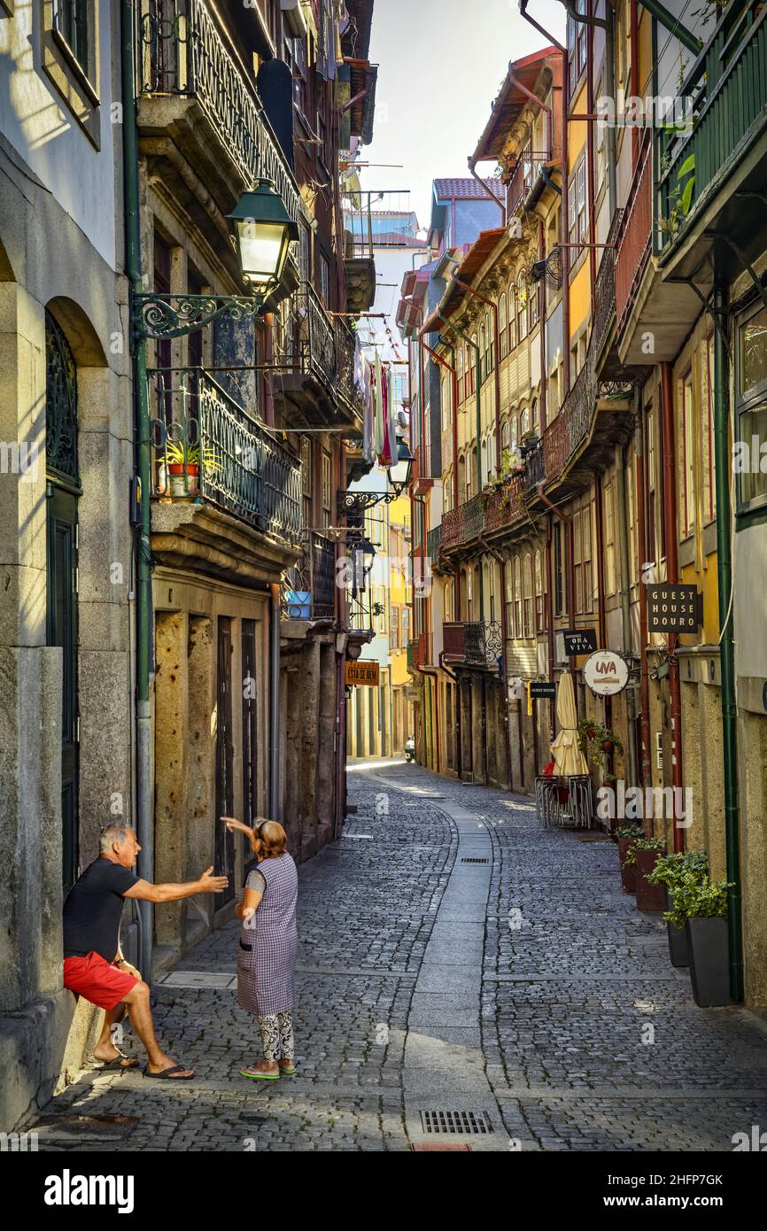 Portugal. Porto. People talking in the street Fonte Taurina, Ribeira ...