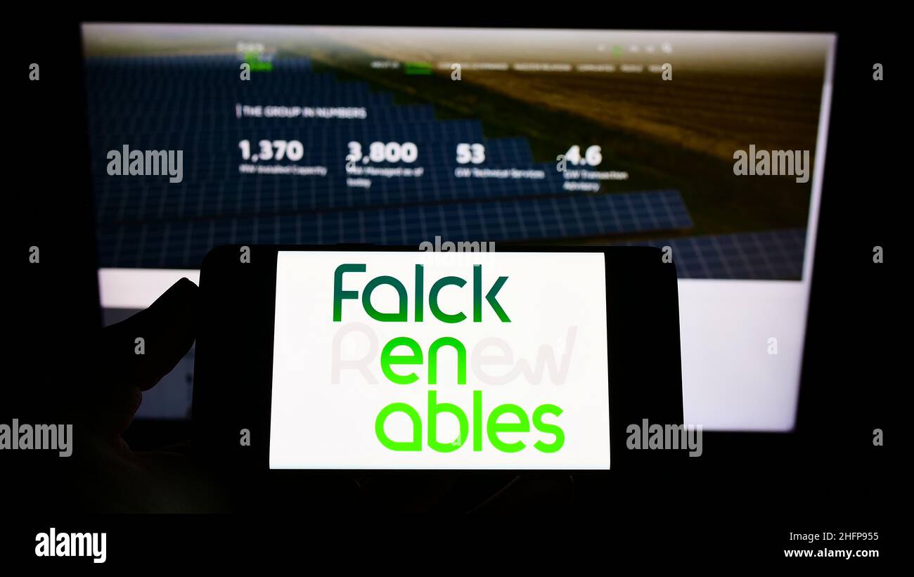 Person holding smartphone with logo of Italian energy company Falck ...