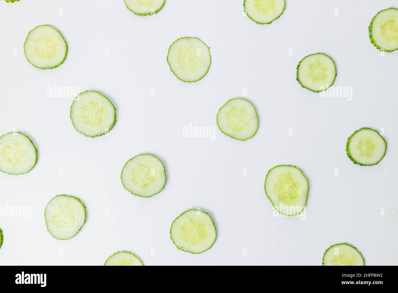 Fresh cucumber round slices on white background, top view Stock Photo ...
