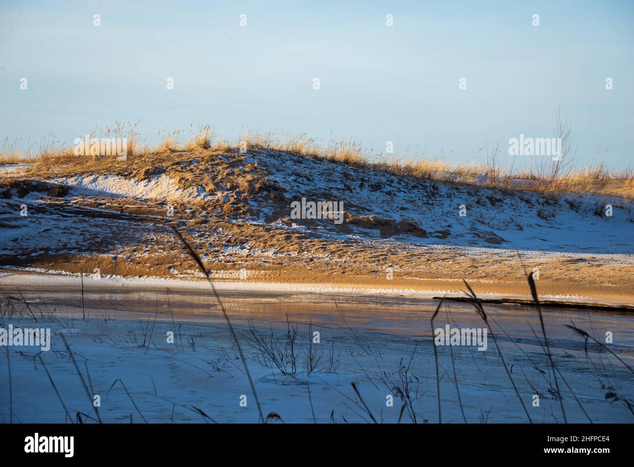icy winter beach near the sea with frozen sand and ice blocks in the ...