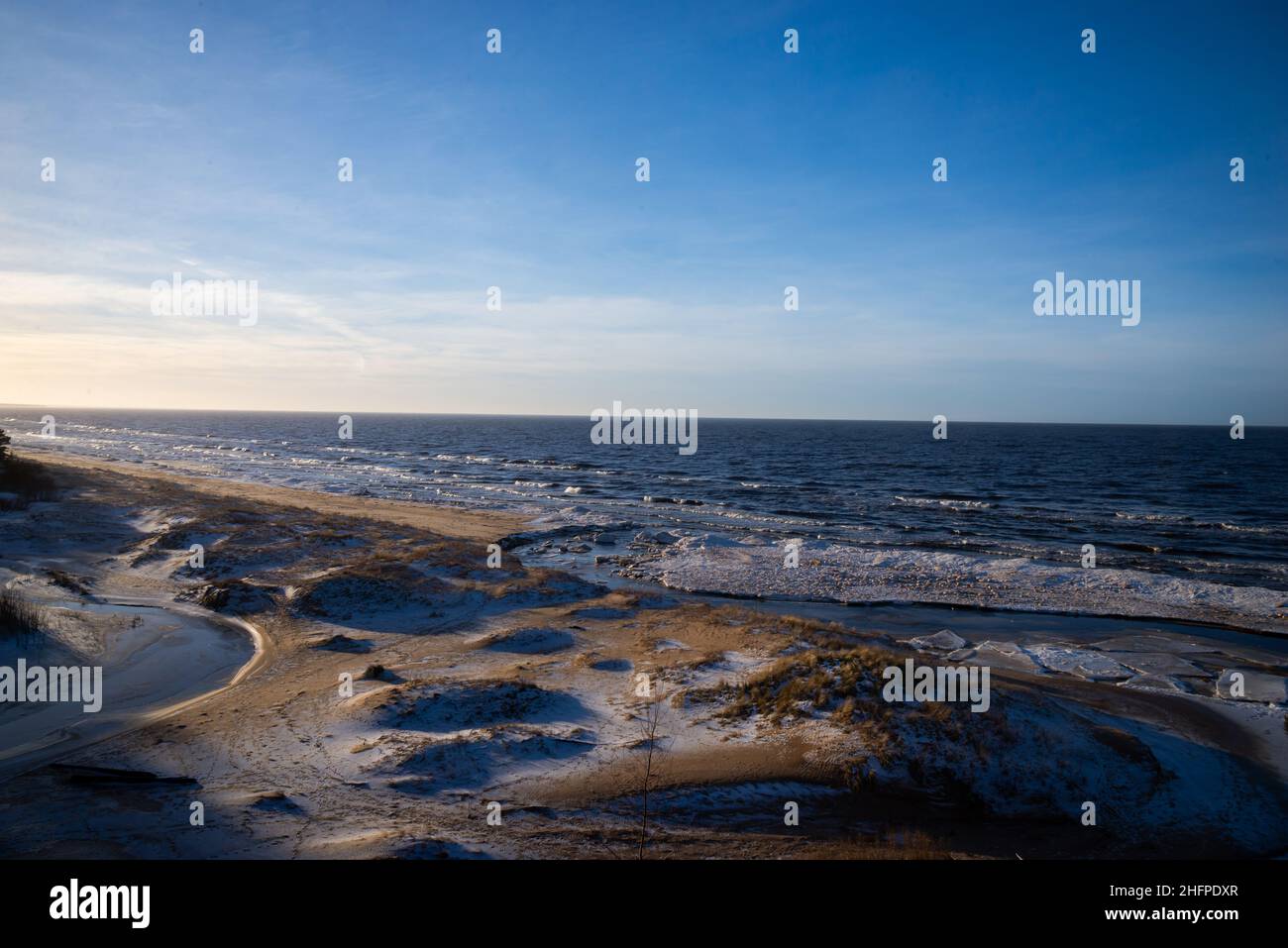 frozen beach view by the baltic sea with sand and ice in water Stock ...