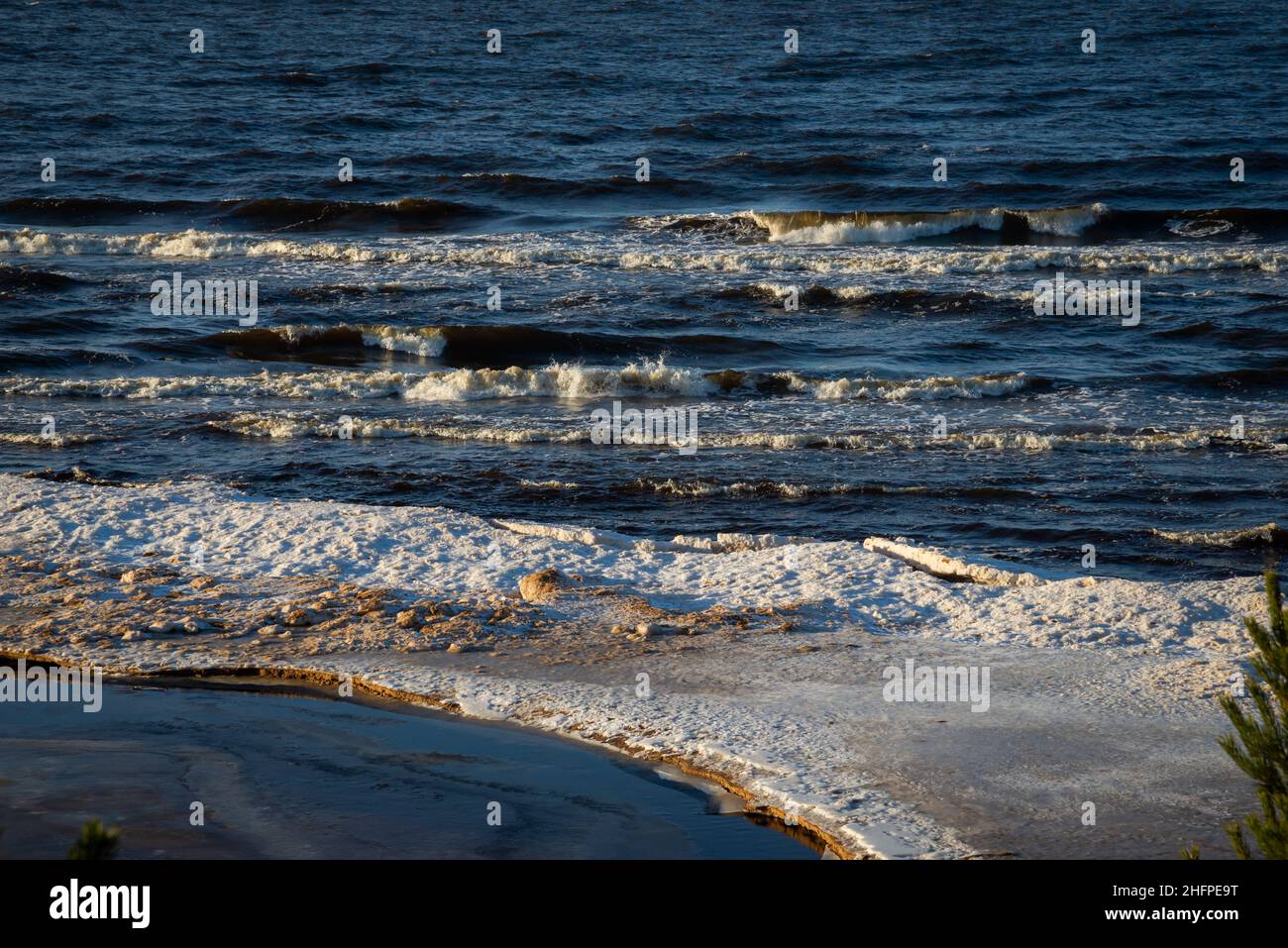 icy winter beach near the sea with frozen sand and ice blocks in the ...
