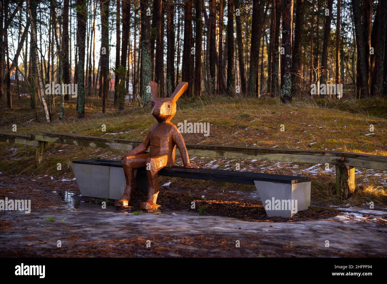 A wooden Easter bunny sitting on a bench on a tourist trail Stock Photo ...