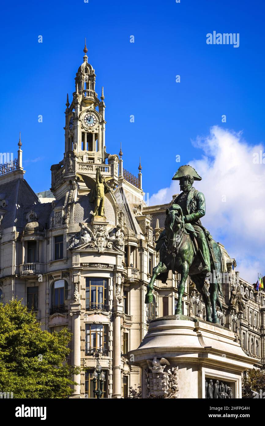 Monument of Peter IV of Portugal. Building facade with statue, clock ...