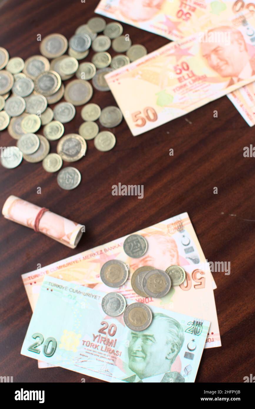 Some Turkish banknotes and coins on a brown background. Some Turkish ...