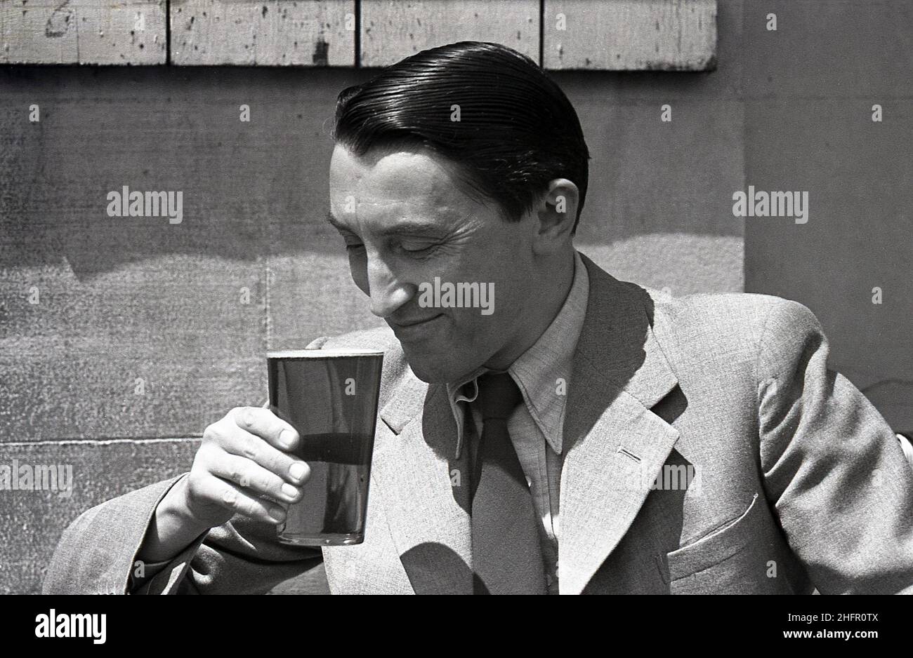 1950s, historical, an Engish gentleman in a jacket & tie sitting ...