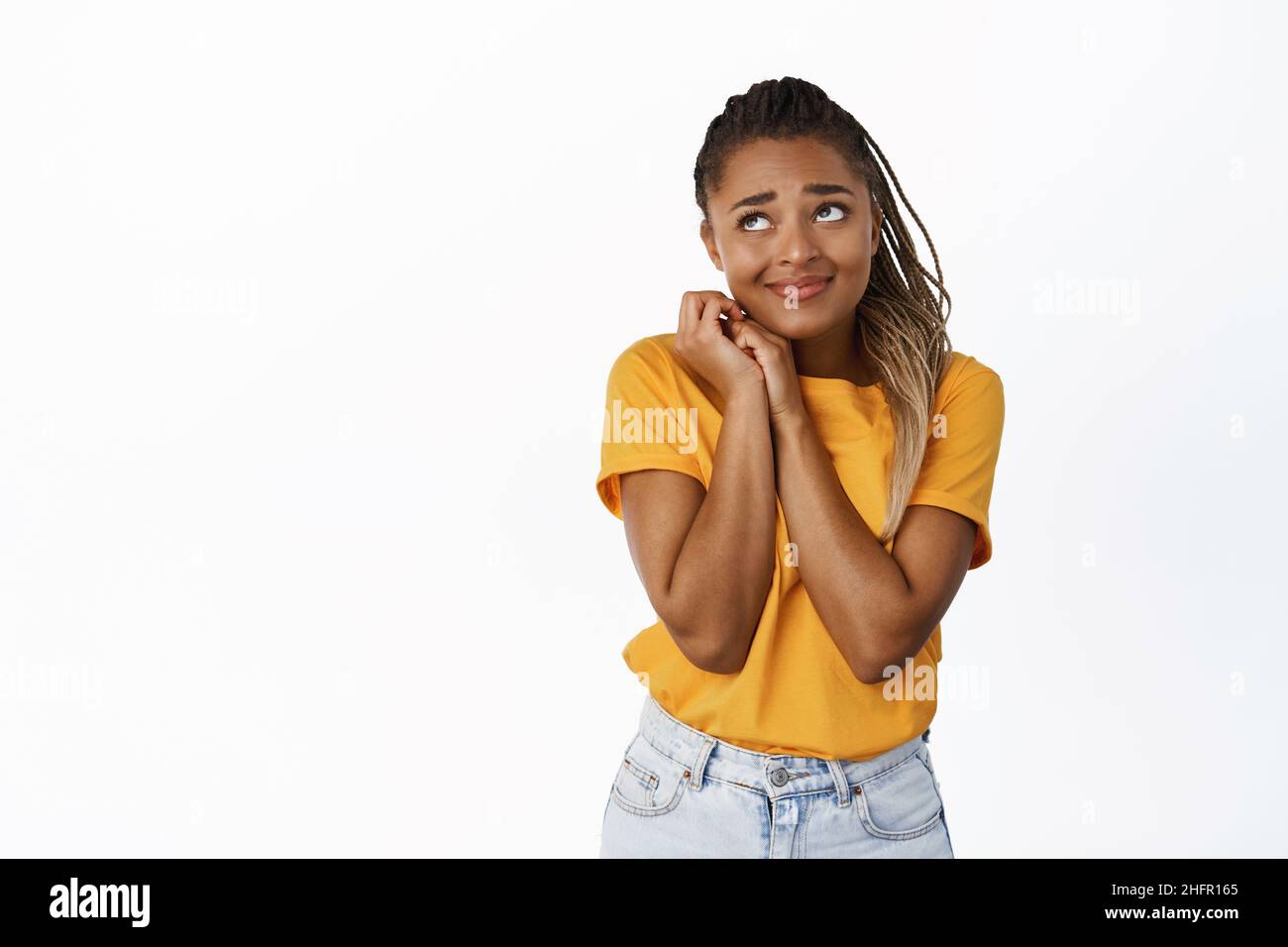 Romantic and cute Black girl sighing, looking aside cute, daydreaming ...