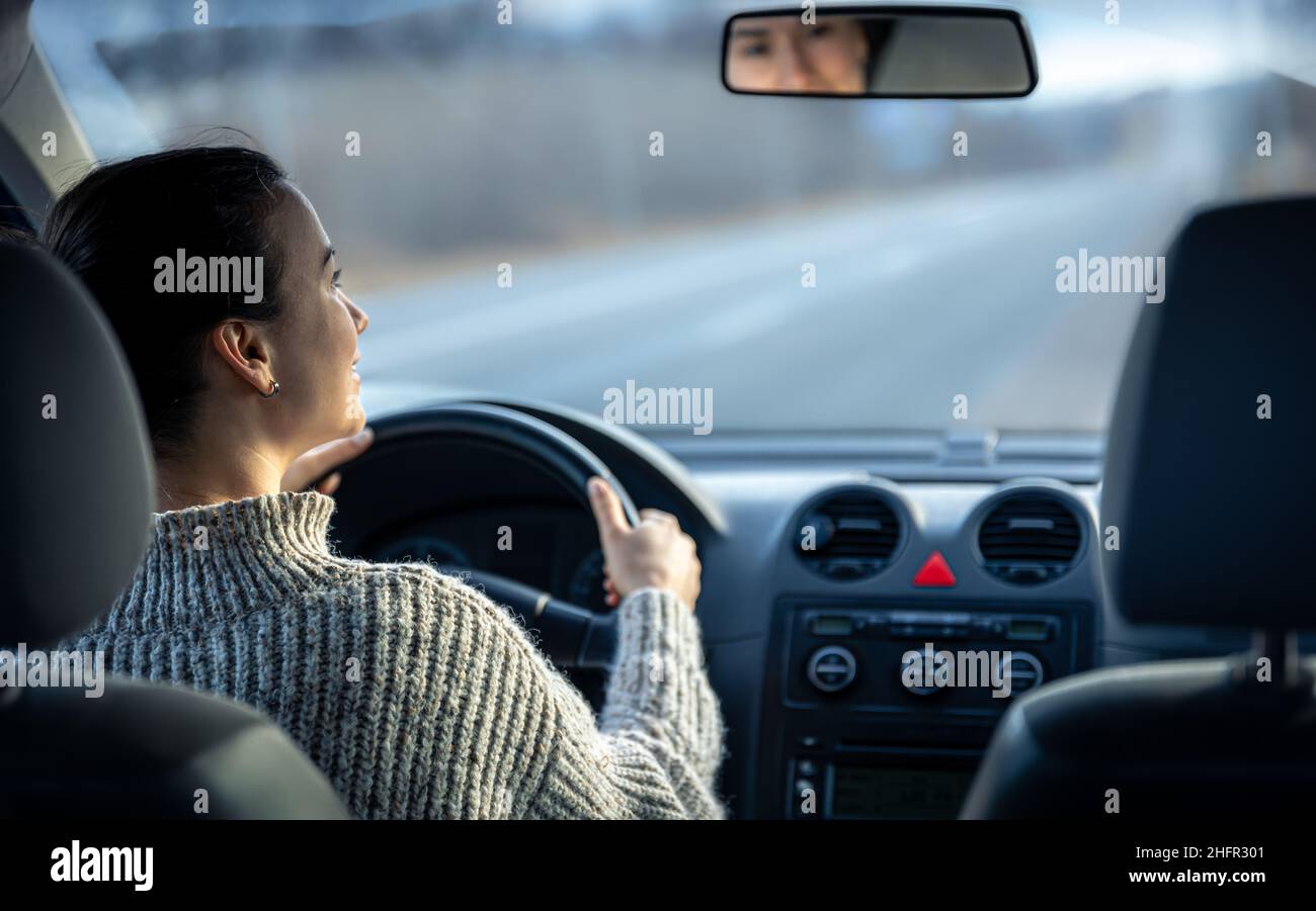 Happy young woman drives a car, inside view Stock Photo - Alamy