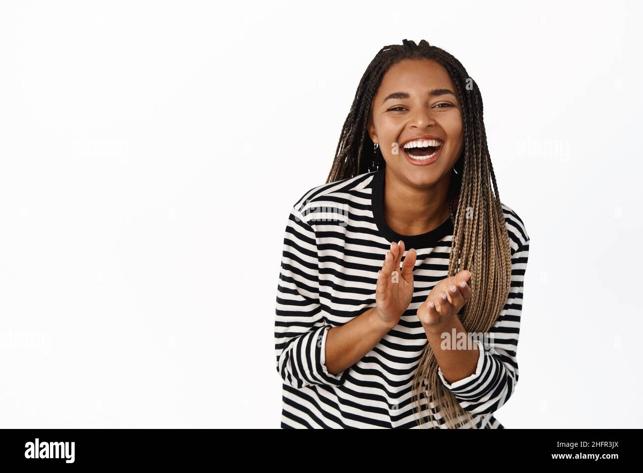 Happy black girl laughing and smiling, applausing, clap hands and ...