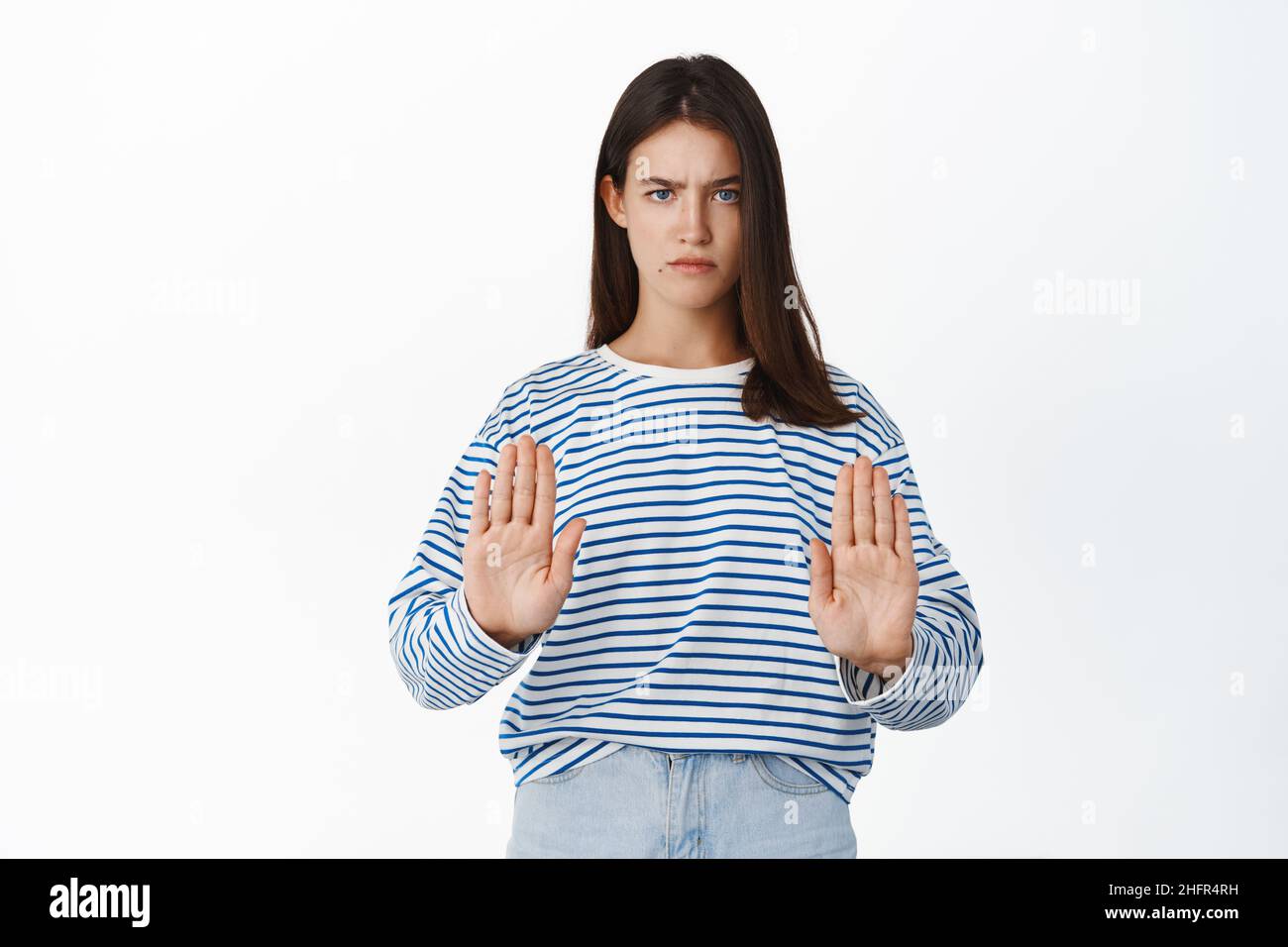 Stop. Young serious woman showing block, prohibition gesture, taboo ...