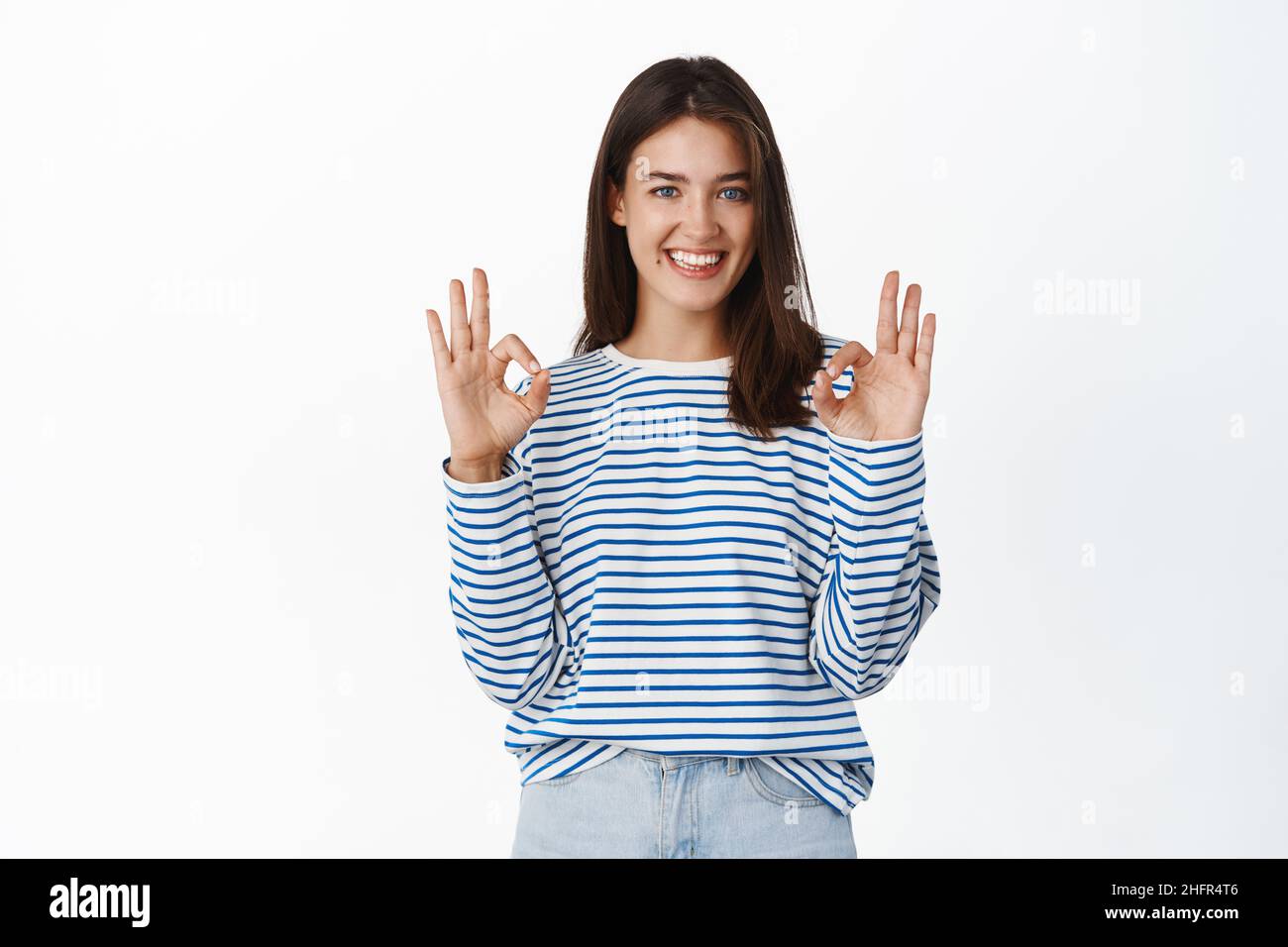 No problem, good. Smiling pleased young woman showing okay, ok sign in ...