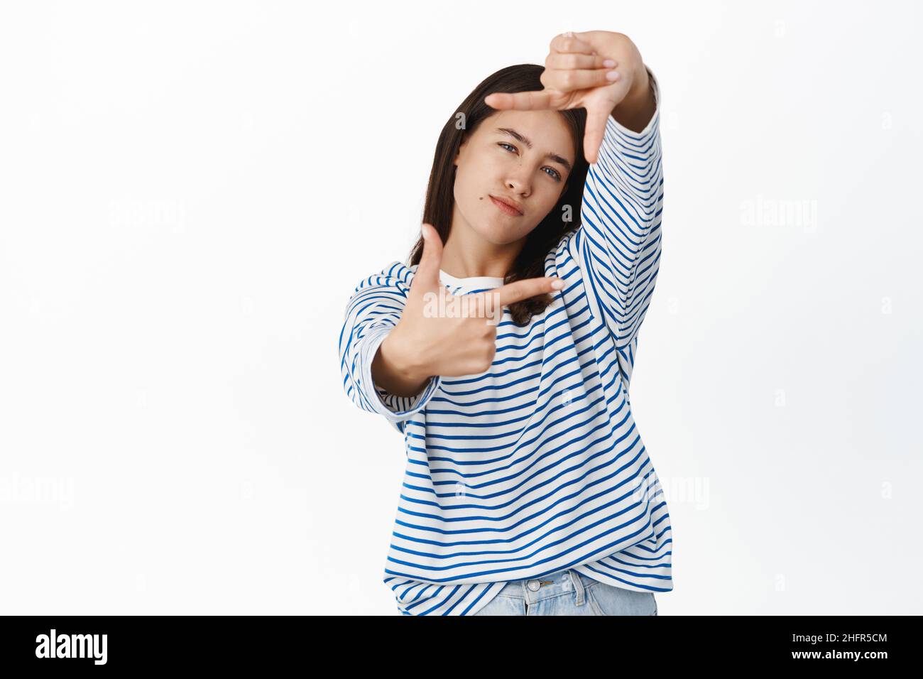 Image of young creative girl measuring angle, looking thoughtful ...