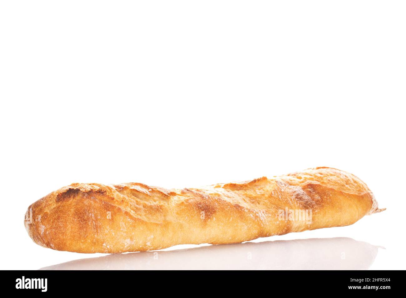 One freshly baked French baguette, close-up, isolated on white Stock ...