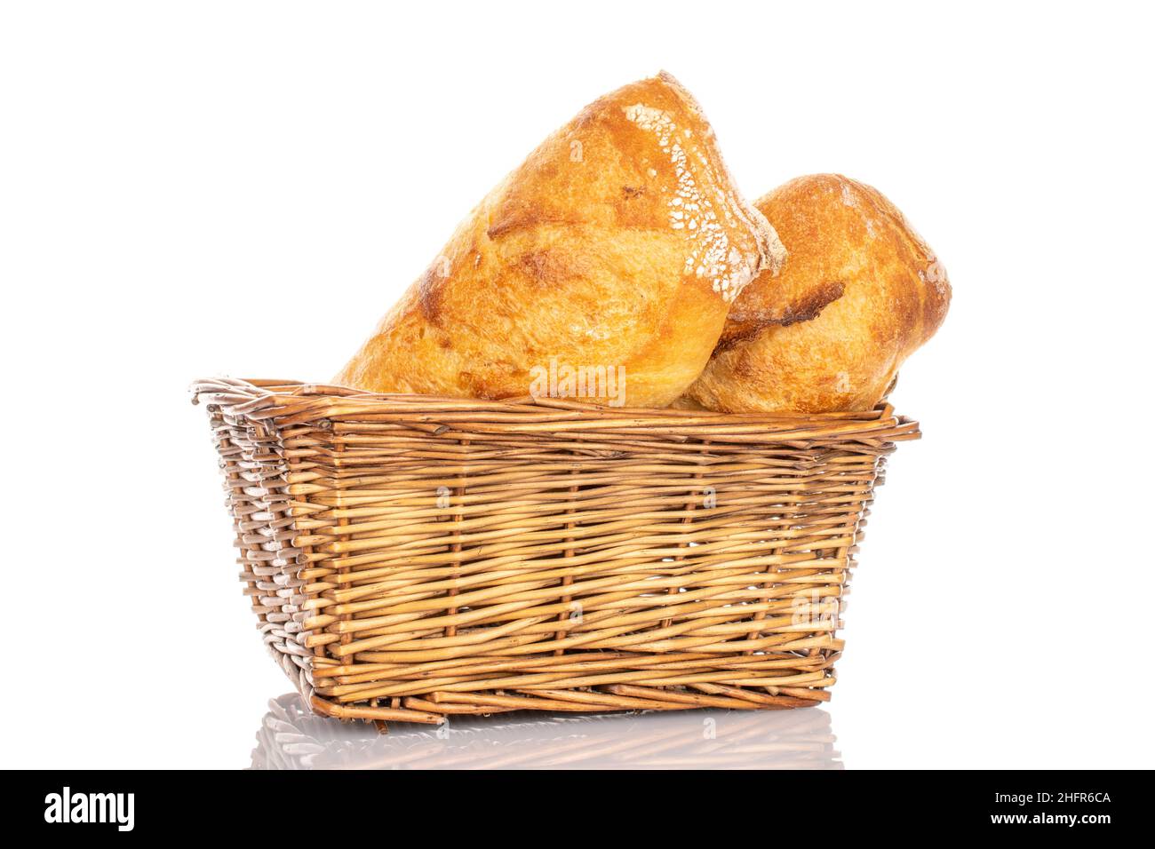 Two delicious freshly baked French baguettes in a basket of vine, close ...