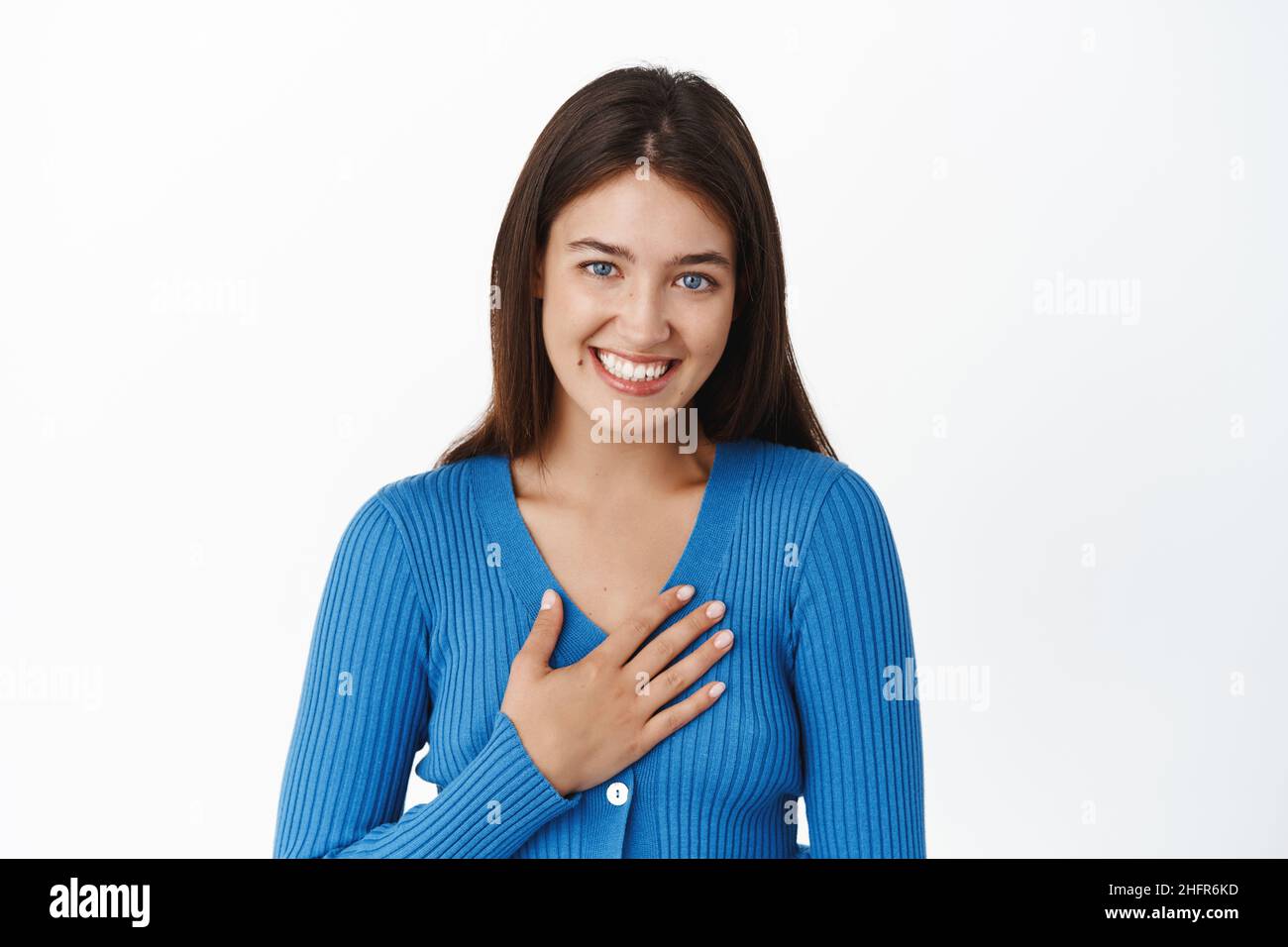Portrait of smiling brunette woman looking thankful, appreciate smth ...