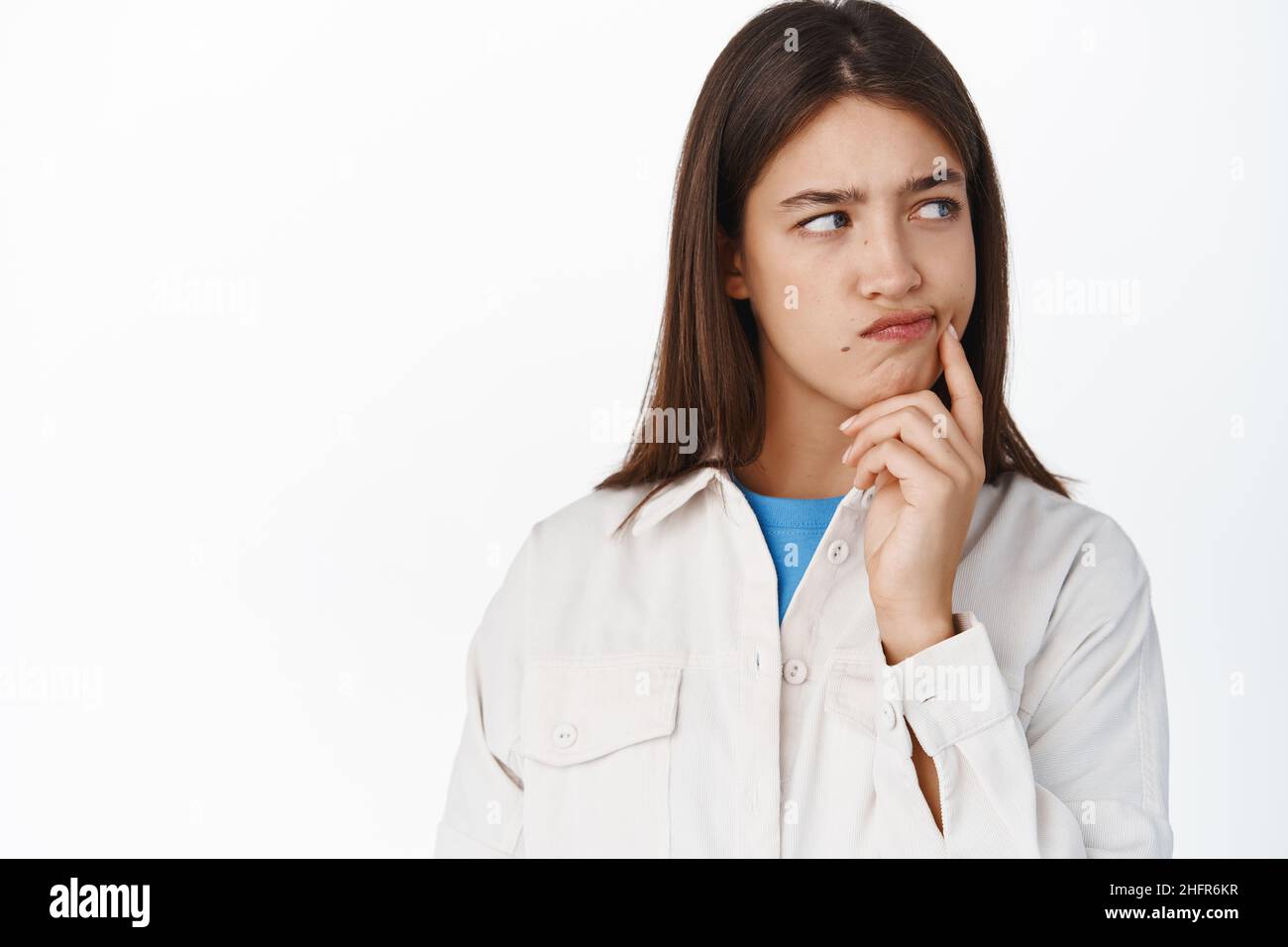 Close up of young brunette woman, student thinking, looking away with ...
