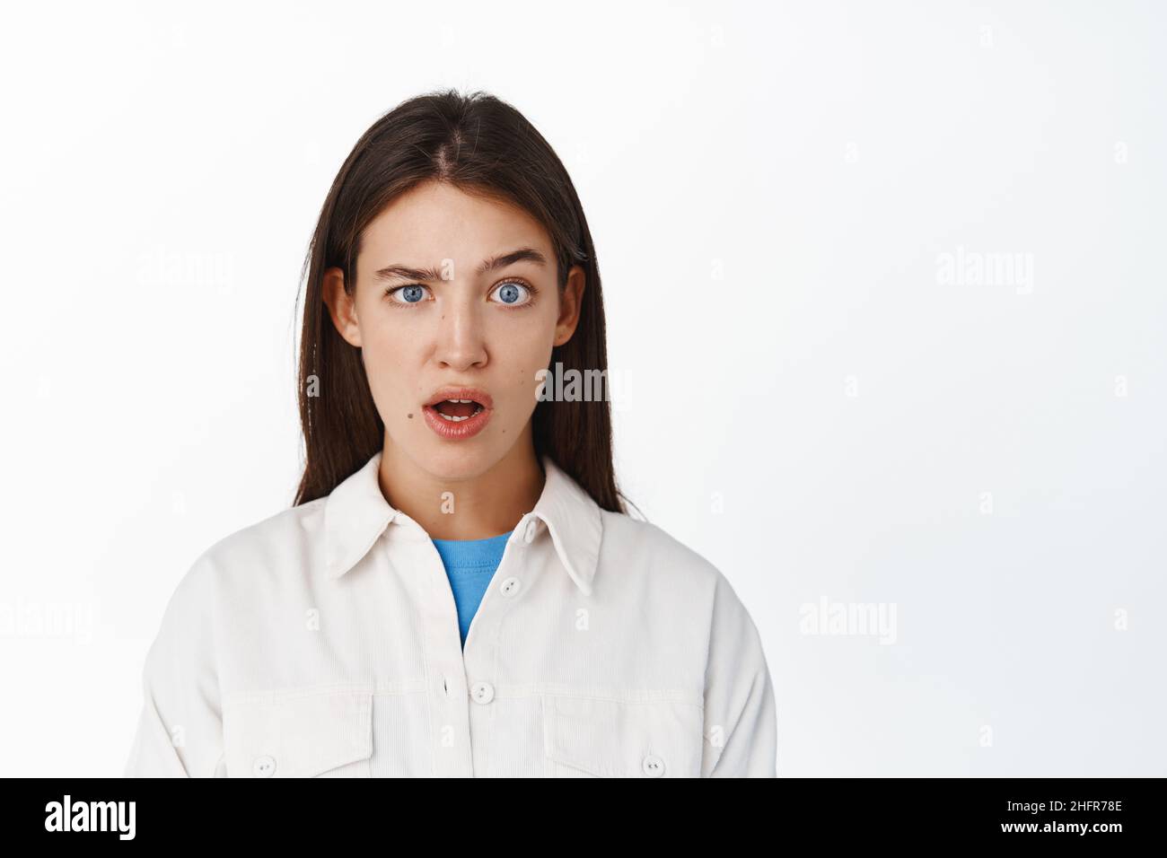 Close up of surprised young woman raising, flick one eyebrow in ...