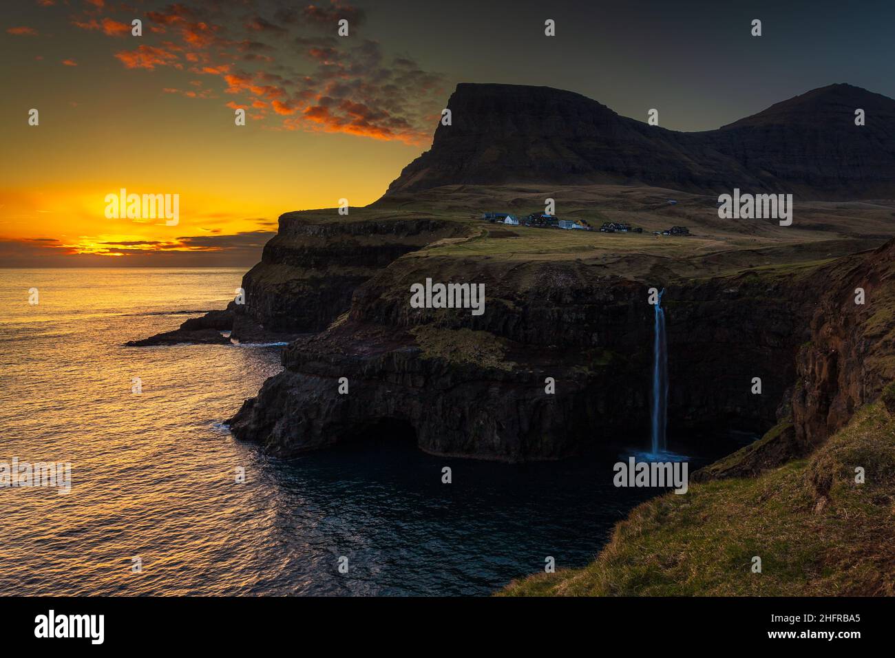View of Mulafossur Waterfall and surrounding coastline from afar ...
