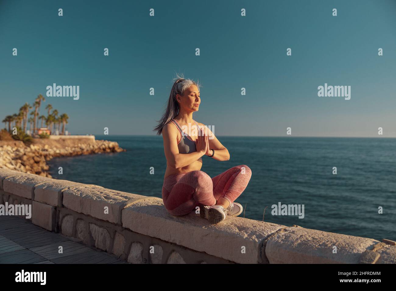 Strong active female training by the waterfront Stock Photo - Alamy