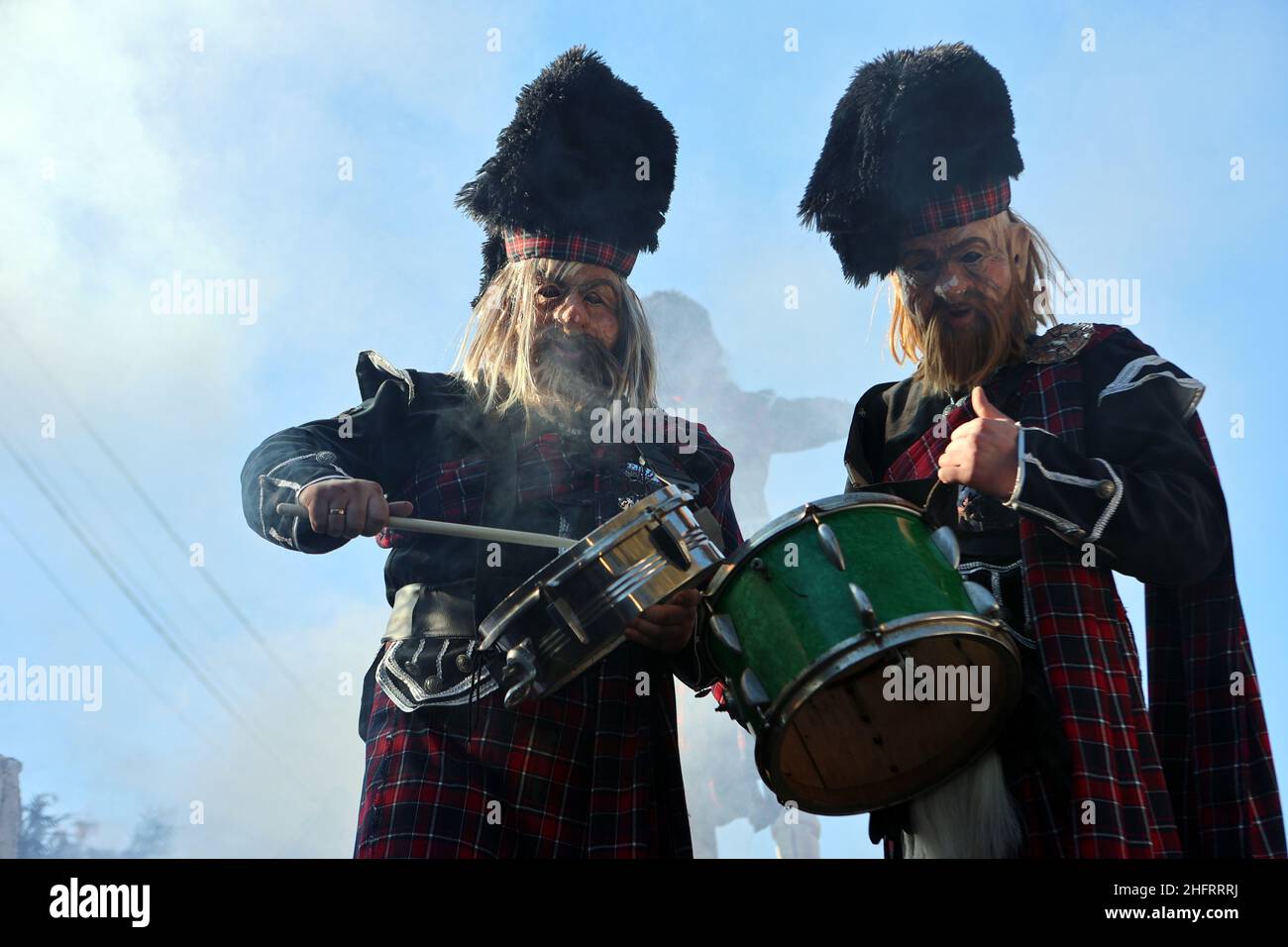 VASHKIVTSI, UKRAINE - JANUARY 14, 2022 - Men in Scottish costumes beat ...