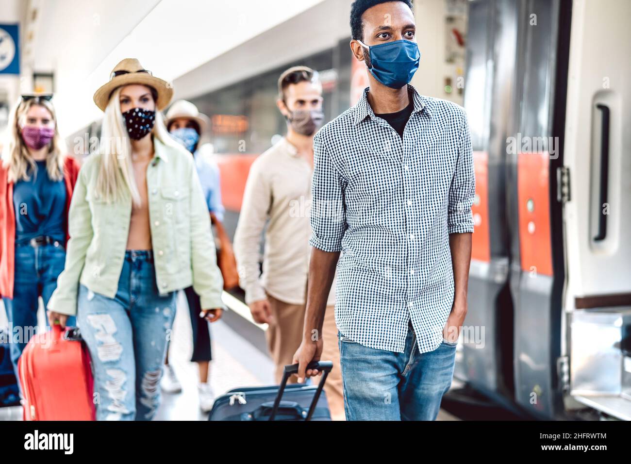 Crowd of people walking at railroad station platform covered by ...