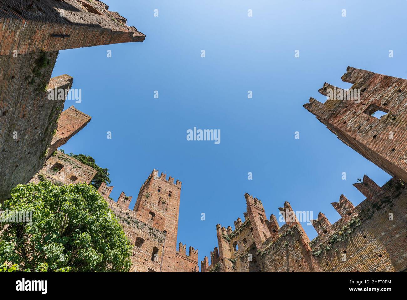 Castell'Arquato castle brick walls and towers with blue sky bottom-up ...