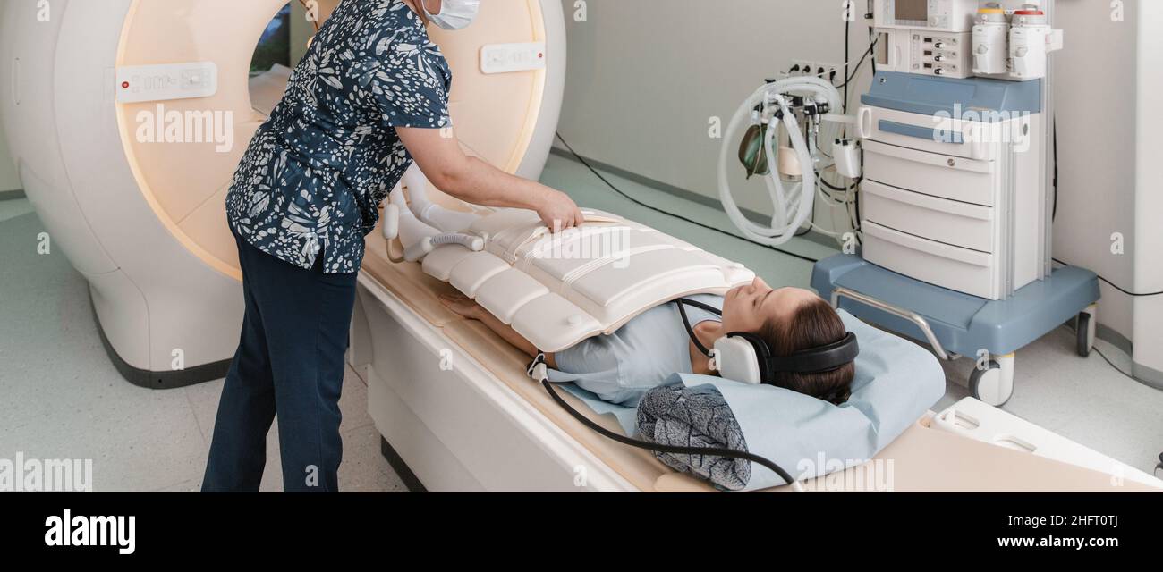 Doctor or nurse and patient with tomography CT or MRI Scan in hospital ...