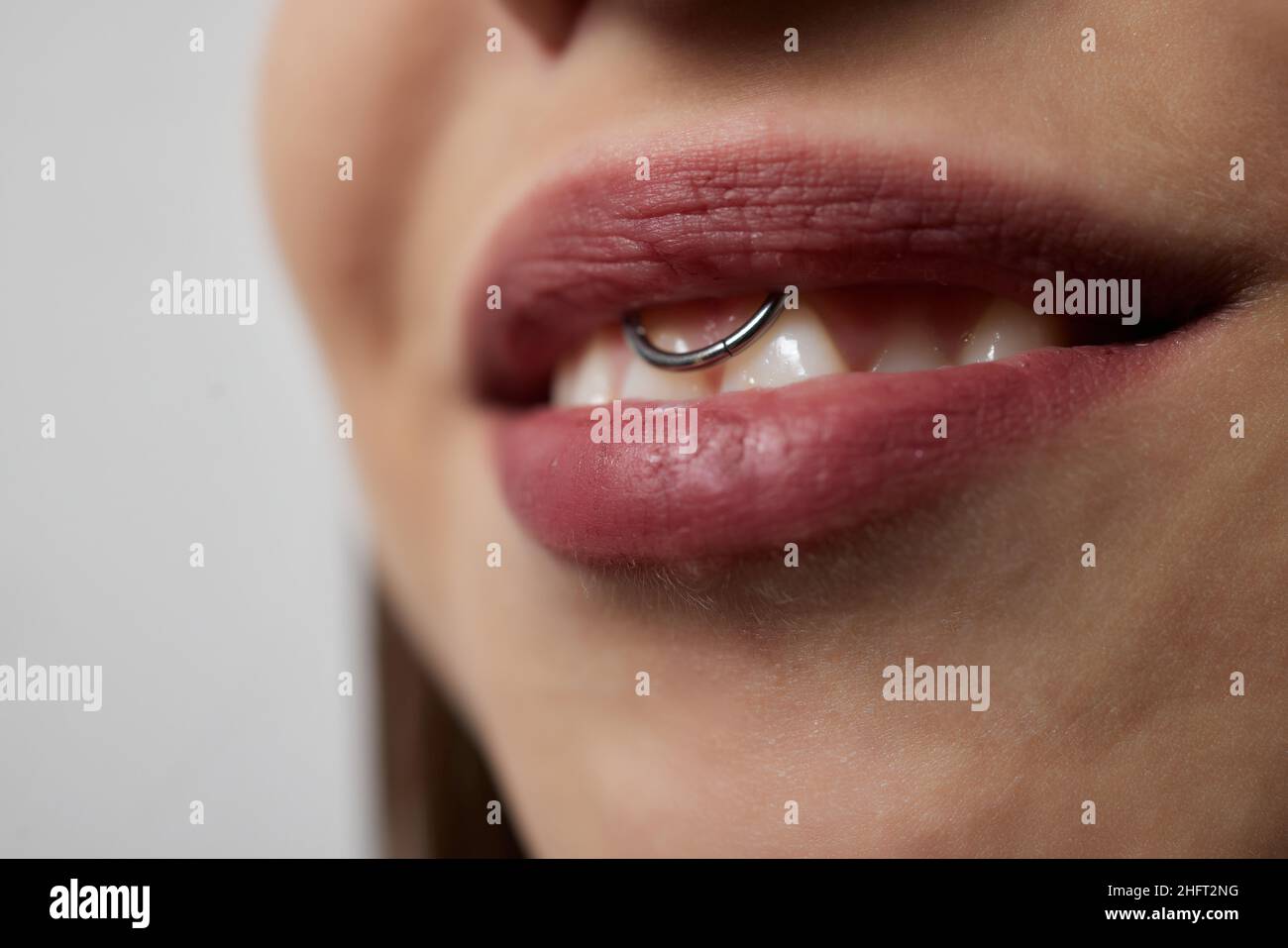 smile or frenulum piercing under the upper lip Stock Photo - Alamy