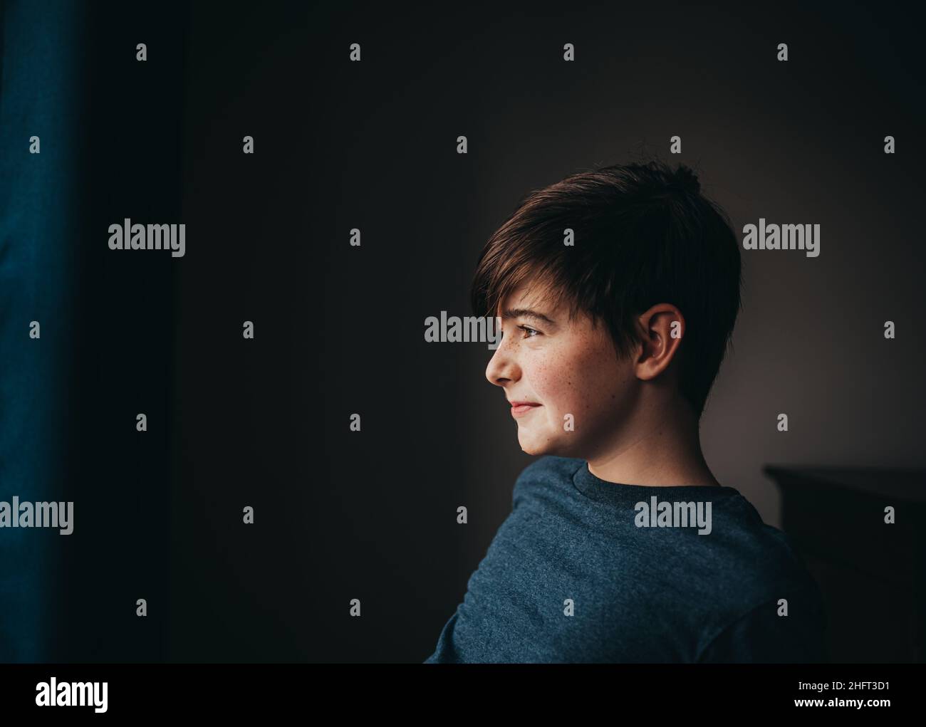Low light profile portrait of caucasian tween boy with brown hair Stock ...