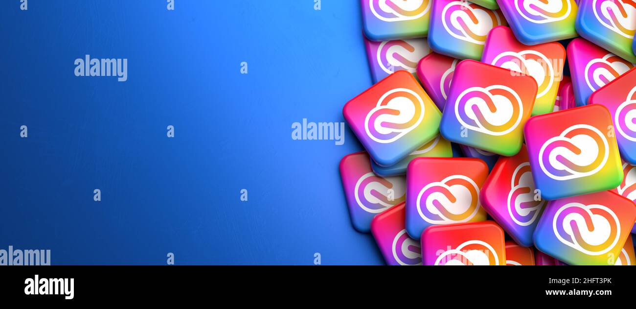 Logos of the graphics software suite Adobe Creative Cloud on a heap on a table. Copy space. Web ...