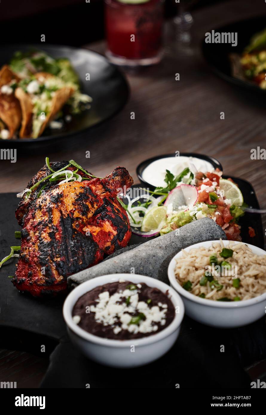 Roasted half chicken with black beans, rice and tortillas Stock Photo ...