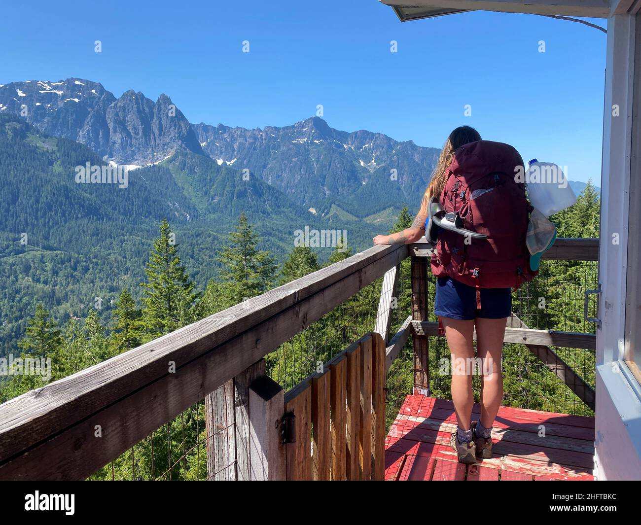 Female with backpack on the deck of Heybrook Fire Lookout Tower Stock ...