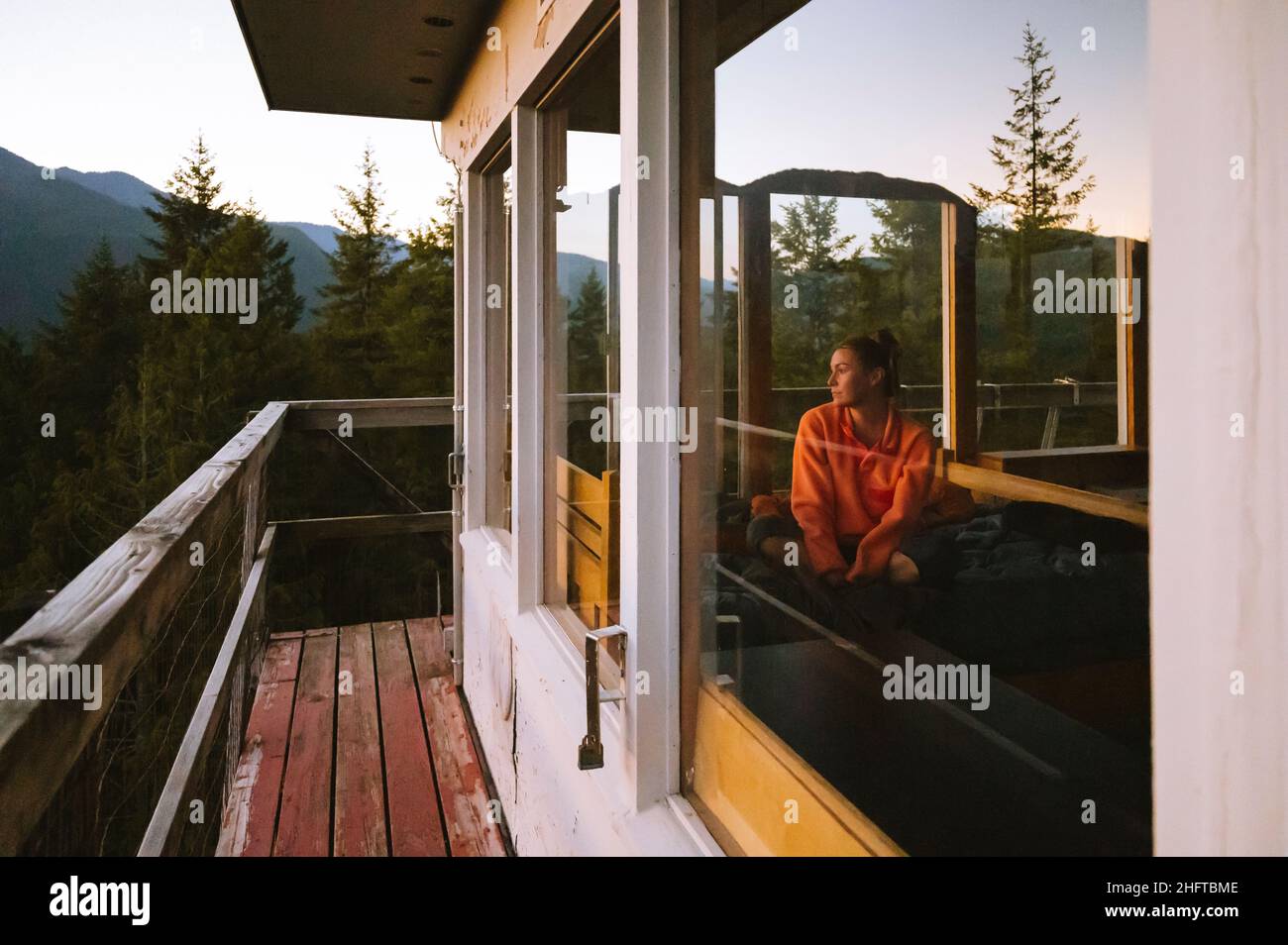 Female watching sunset from inside Heybrook fire lookout tower Stock ...