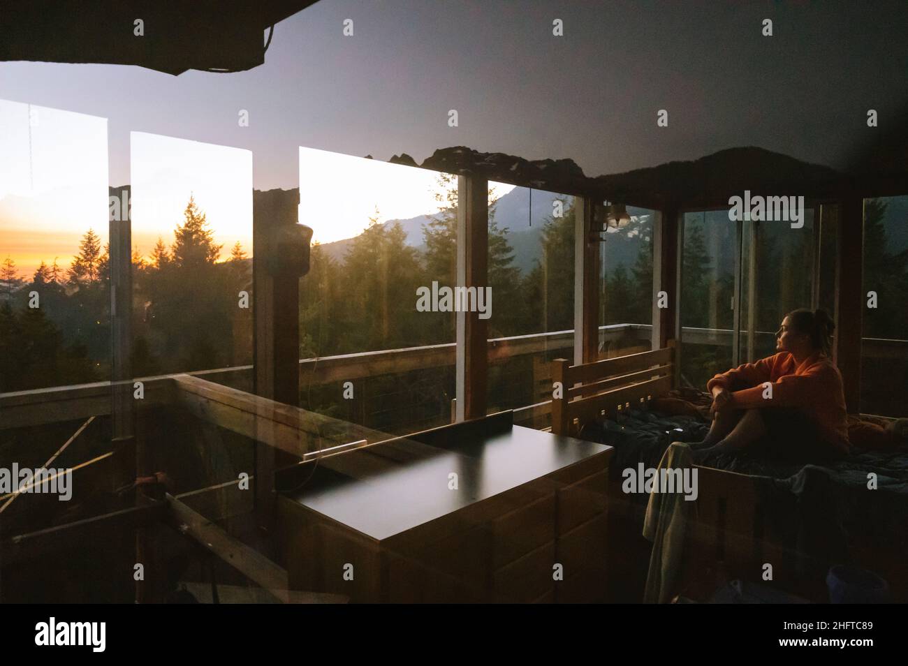 Female watching sunset from inside Heybrook fire lookout tower Stock ...