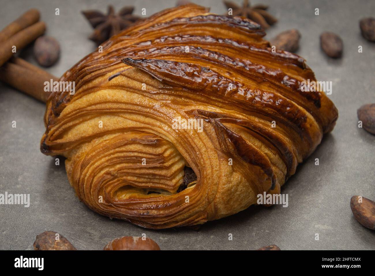 pain au chocolat on a gray background with cinnamon cocoa beans and ...