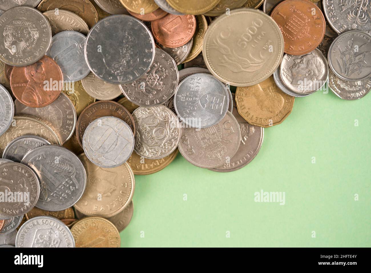 Coins on light green background with copy space. Various vintage coins ...