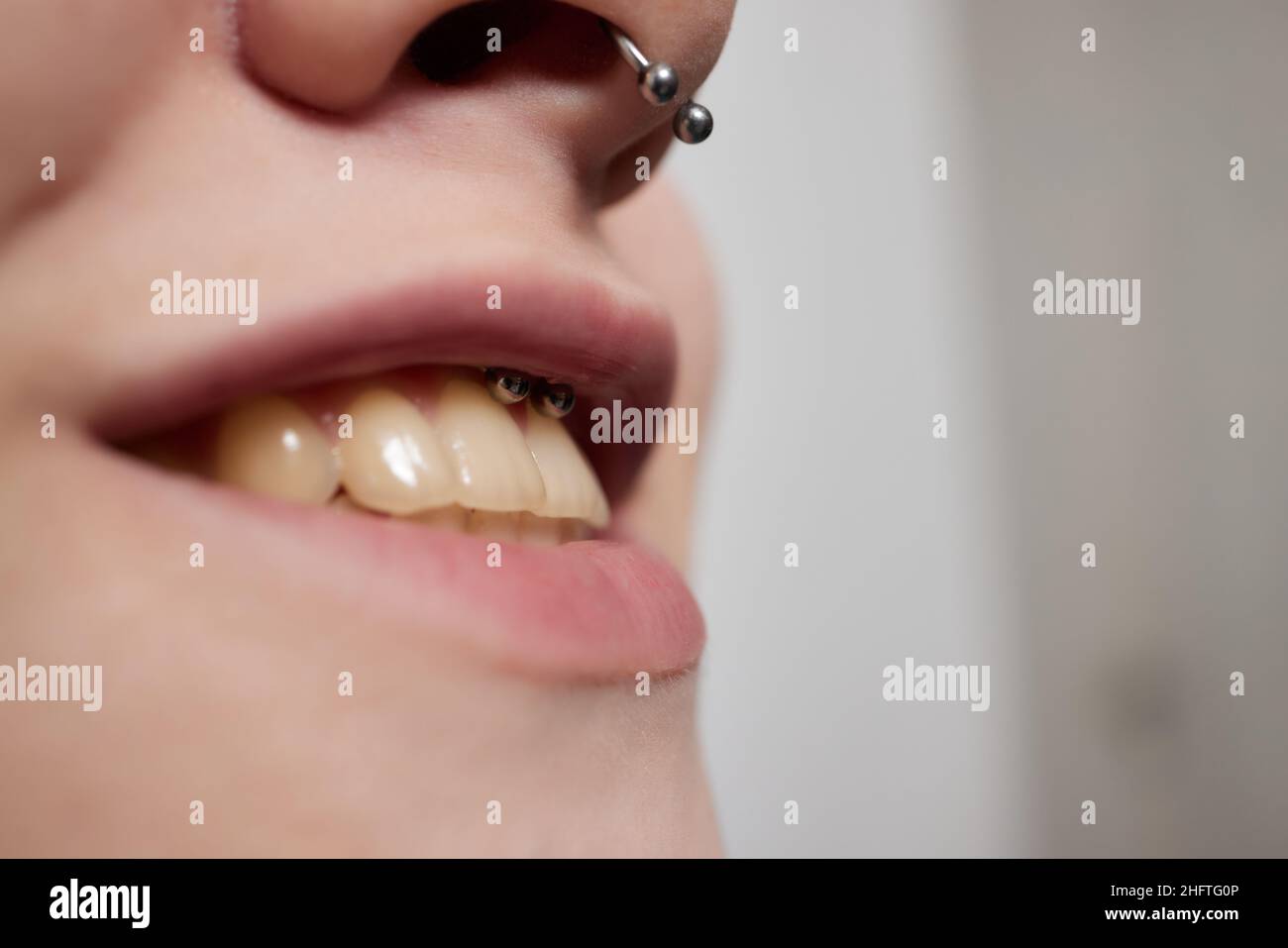 smile or frenulum piercing under the upper lip Stock Photo - Alamy