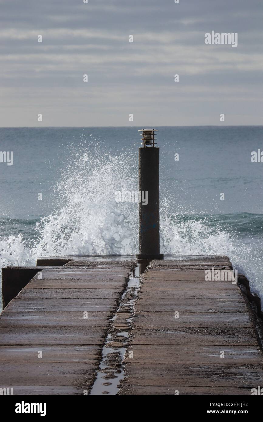 big ocean wave hit in a jetty in a stormy day Stock Photo - Alamy